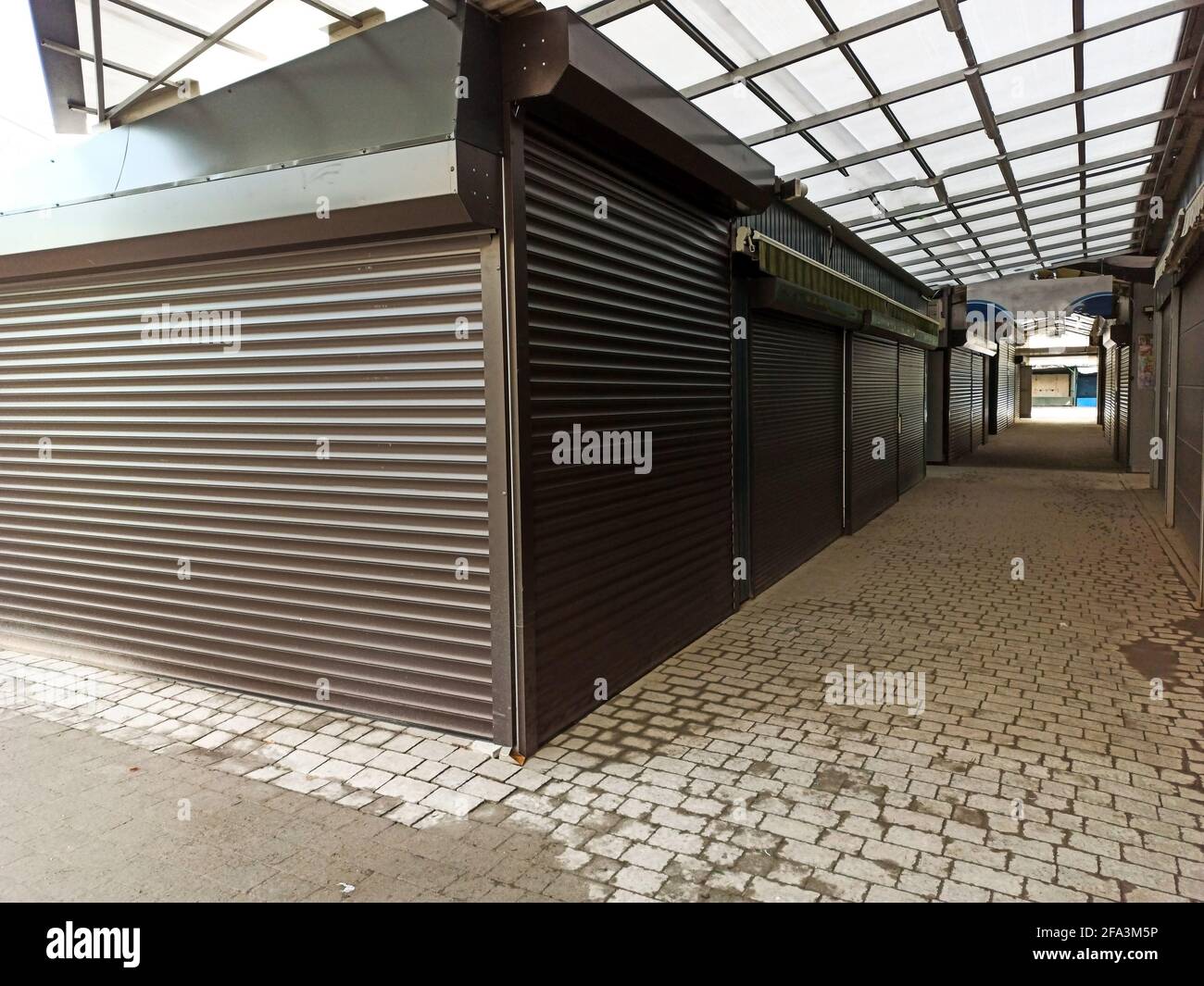 Alleyway of closed shutter of shops in the market during winter ...