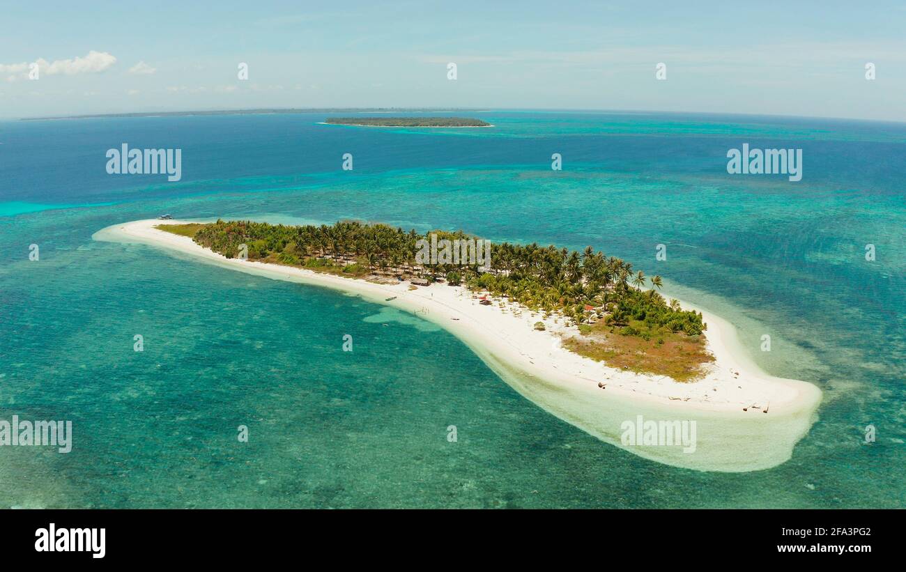 Tropical island Canimeran with sandy beach in the blue sea with coral ...
