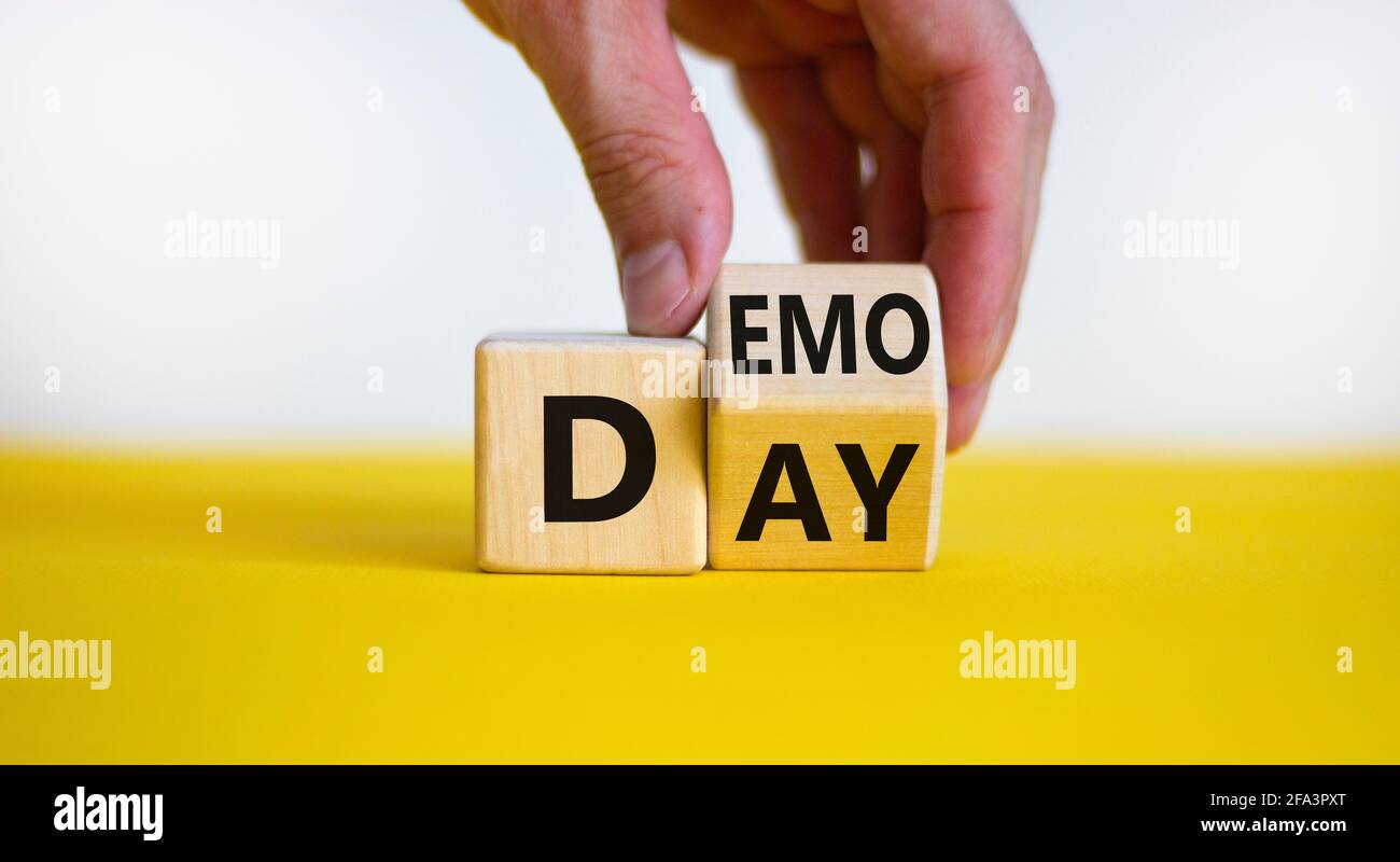 Demo day symbol. Businessman turns a cube and changes the word 'day' to ...