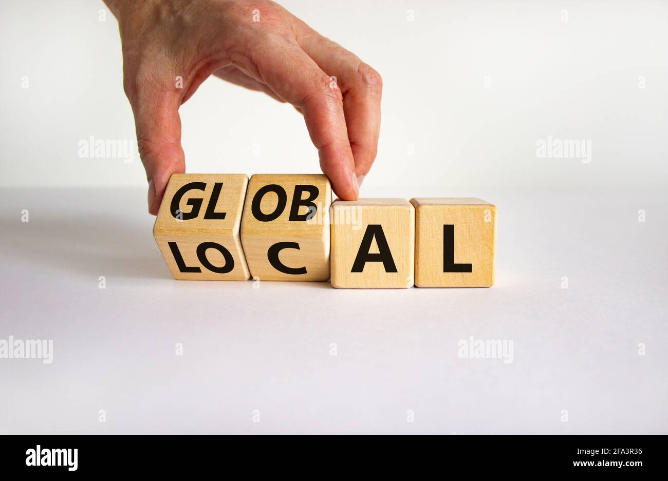 Local or global symbol. Businessman turns wooden cubes and changes the ...