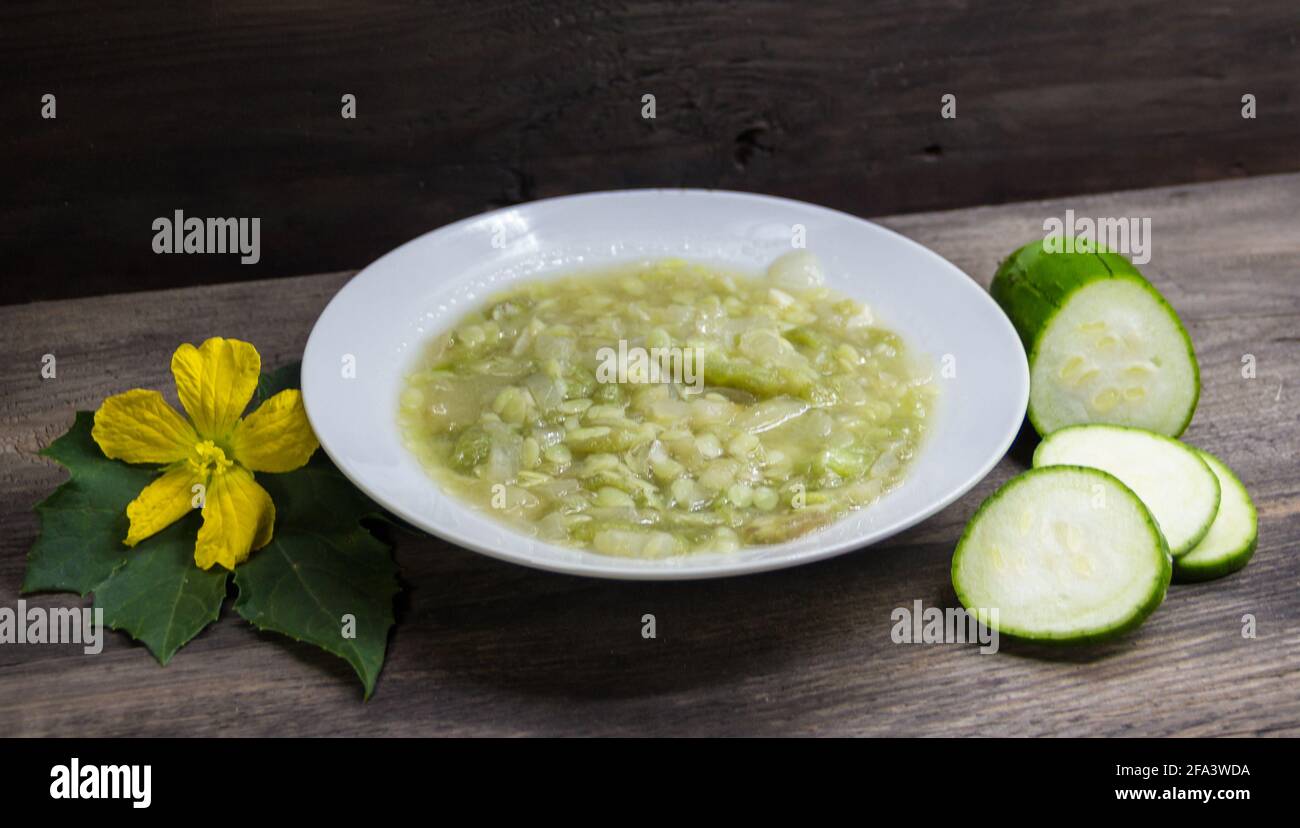 Plate of fried luffa with onion and garlic. Asian kitchen Stock Photo ...
