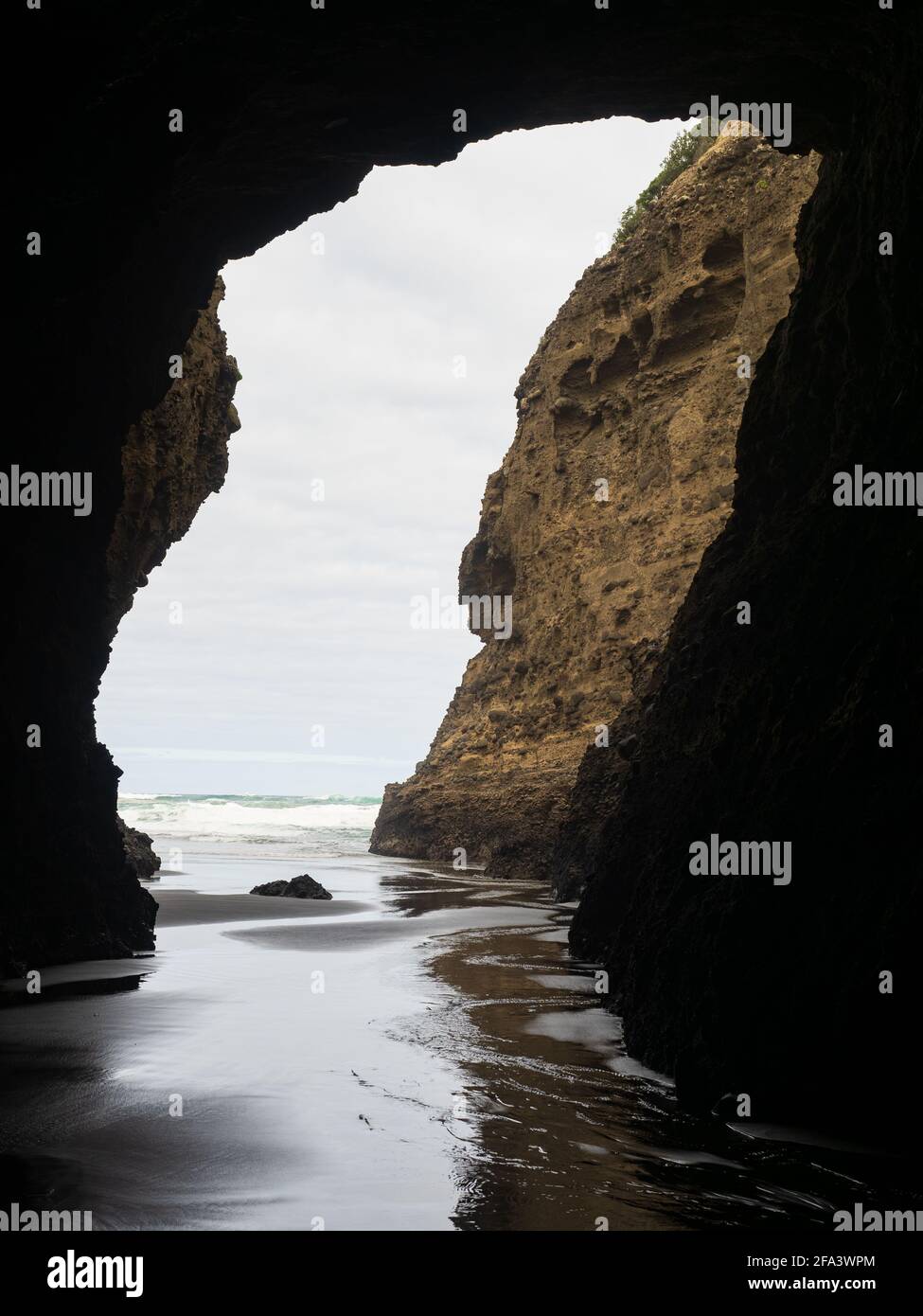 from darkness of Piha Blowhole cave to ocean Stock Photo - Alamy