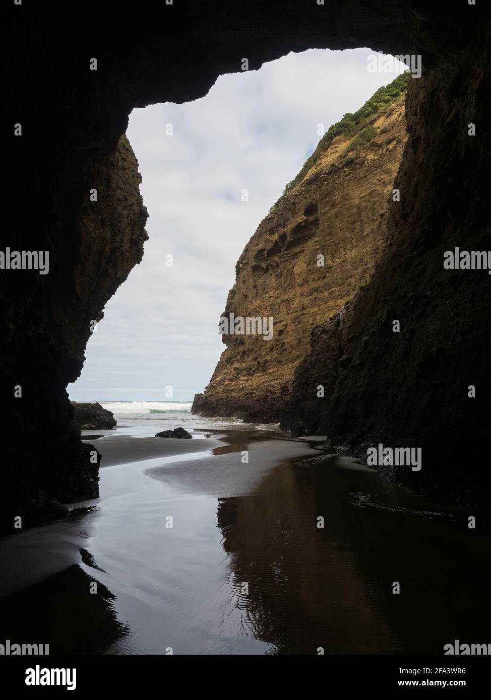 from darkness of Piha Blowhole cave to ocean Stock Photo - Alamy