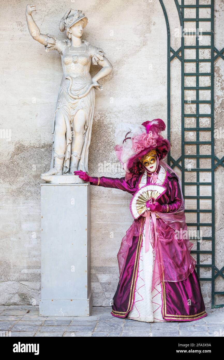 Model wearing a Venetian costume leaning on an ancient statue Stock ...