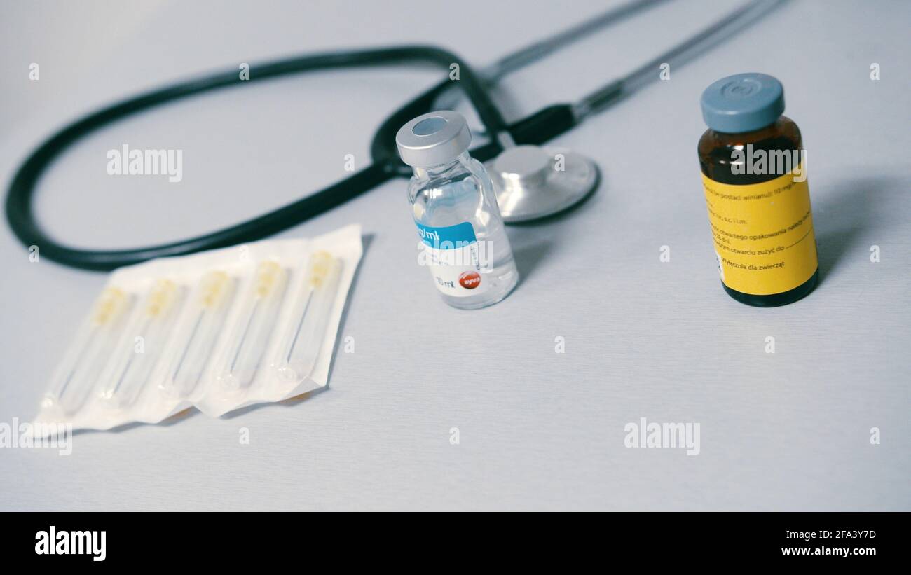 Stethoscope, injection needles and glass bottles with medication laying ...