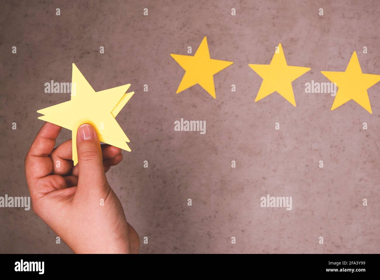 Customer Experience Concept. Three yellow stars on concrete background ...