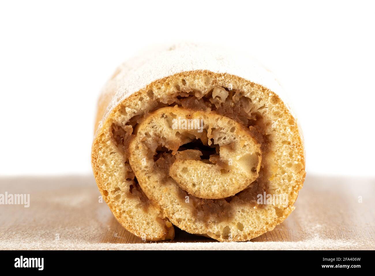 Close-up cut of apple roll sprinkled with powdered sugar. Roll on a ...