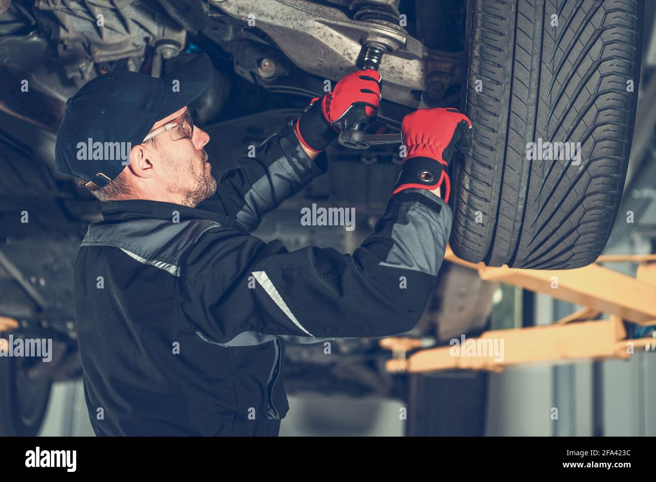 Caucasian Automotive Mechanic in His 30s Replacing Car Suspension ...