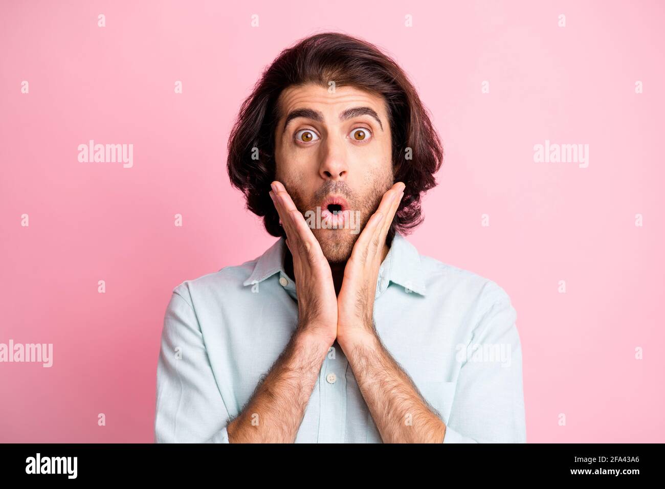 Close up photo of confused person hands on cheeks open mouth staring ...