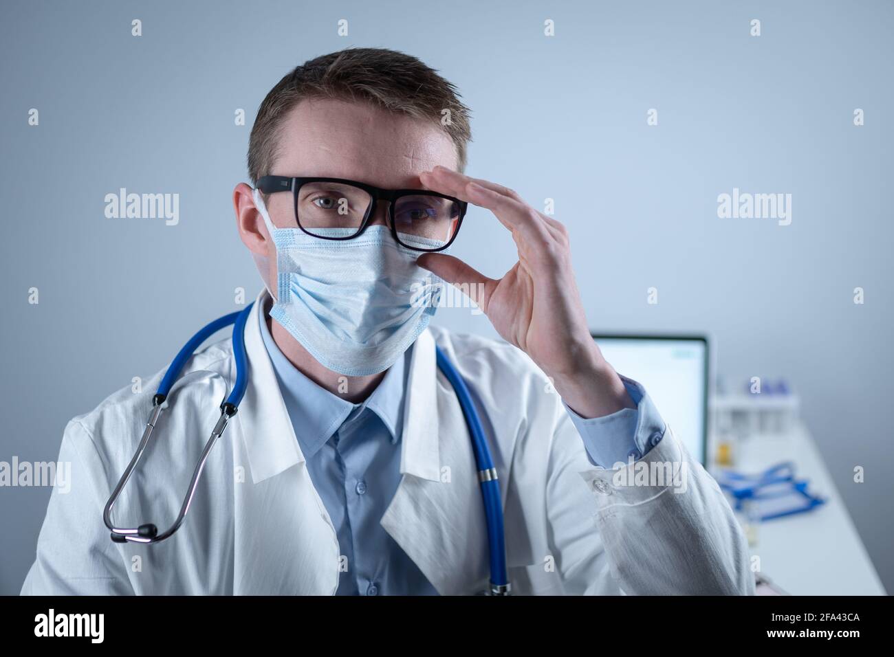 Doctor takes off white mask hi-res stock photography and images - Alamy