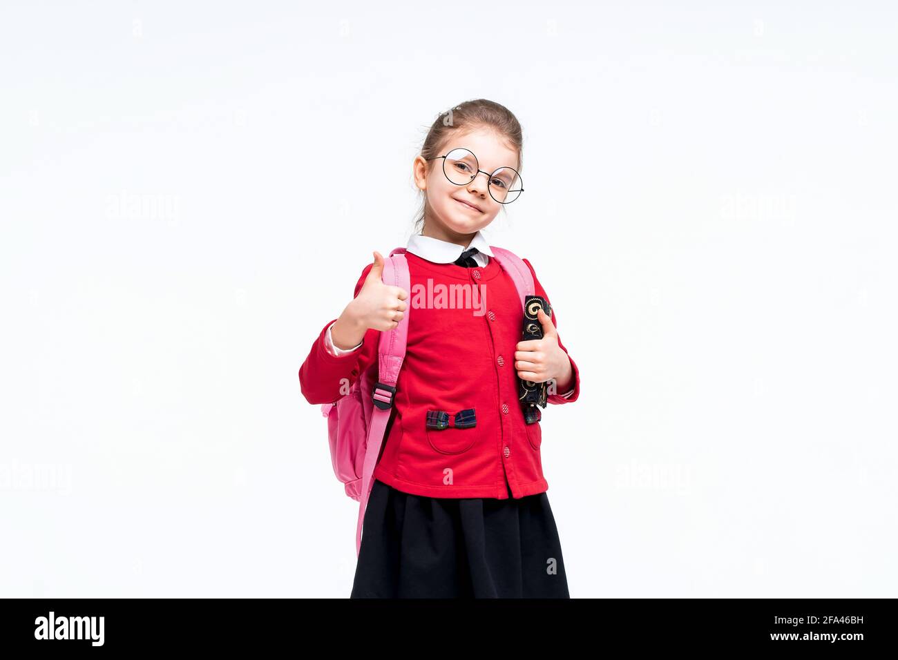 Adorable little girl in red school jacket, black dress, rounded Stock ...