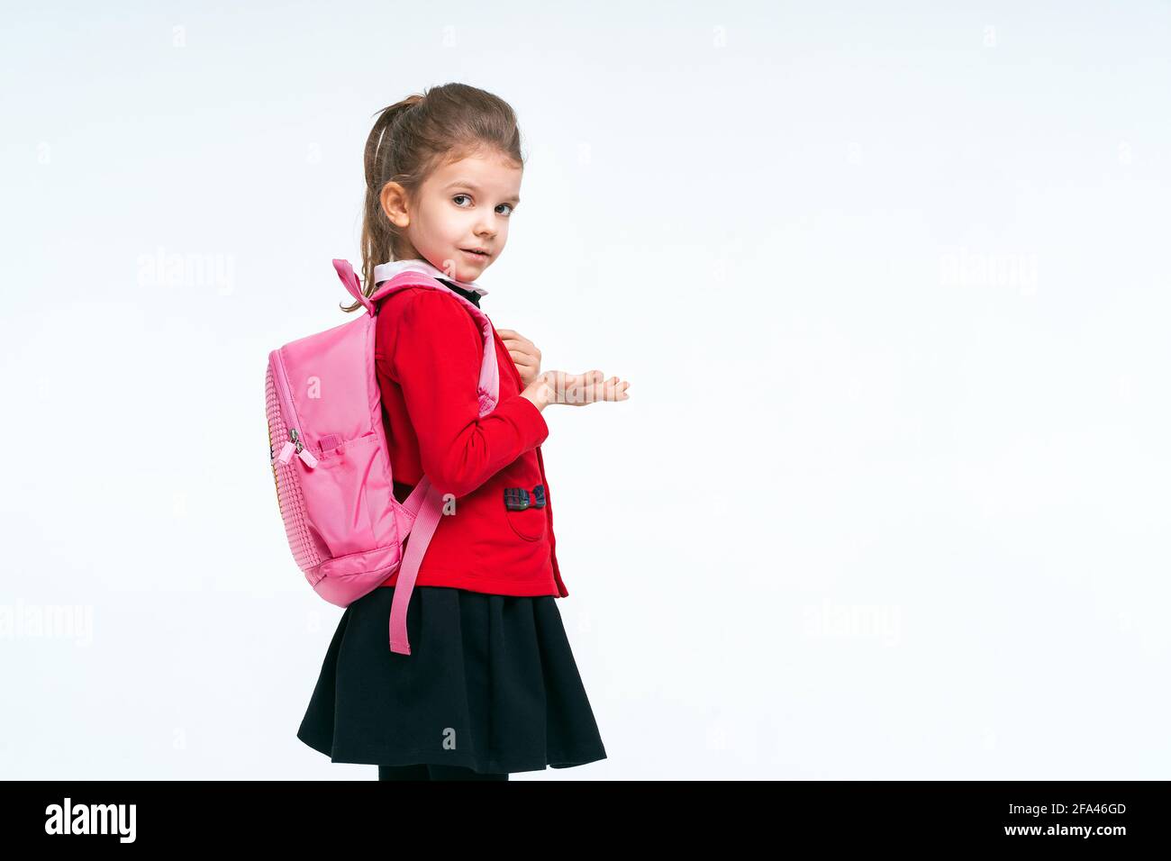 Adorable little girl in red school jacket, black dress, on to th Stock ...