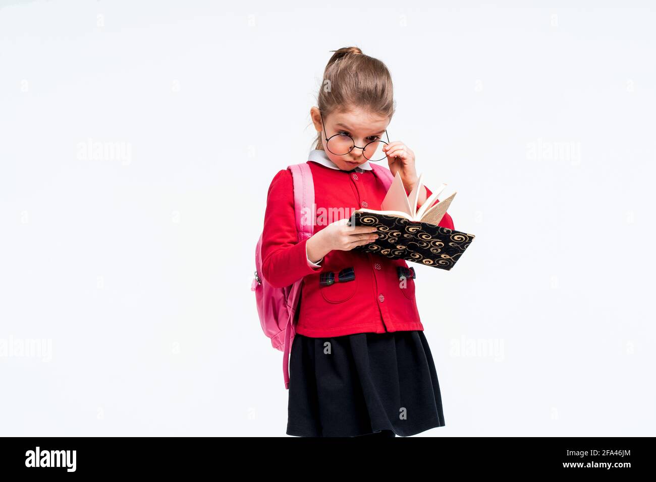 Adorable little girl in red school jacket, black dress, backpack Stock ...