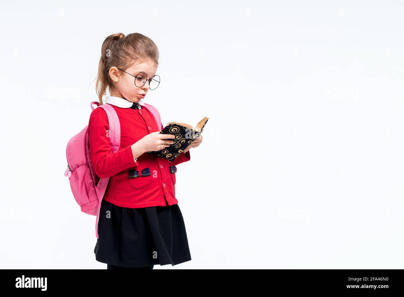 Adorable little girl in red school jacket, black dress, backpack Stock ...