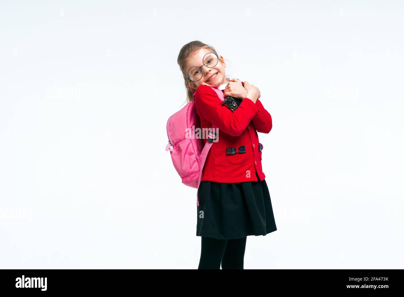 Adorable little girl in red school jacket, black dress, backpack Stock ...