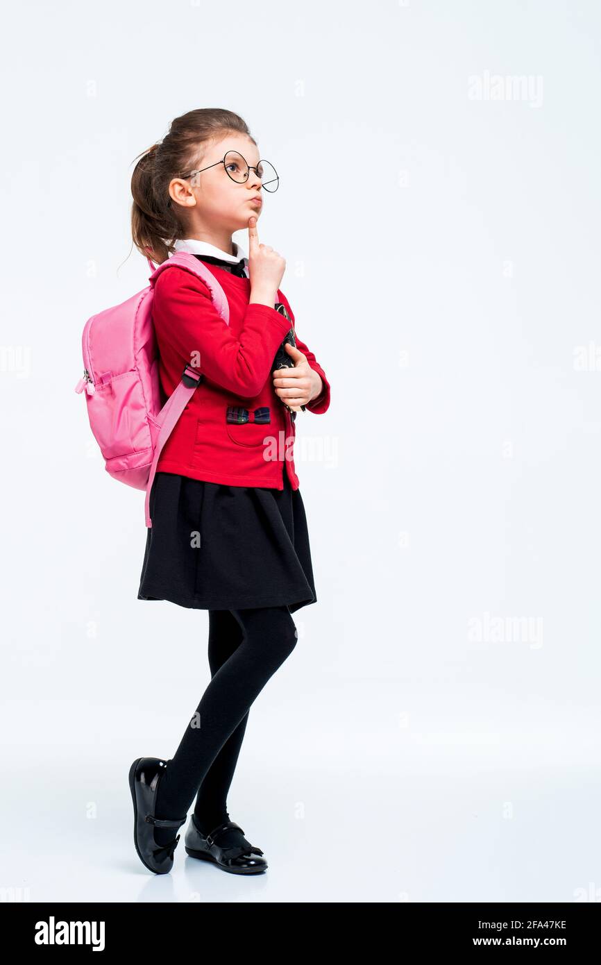 Adorable little girl in red school jacket, black dress, backpack Stock ...