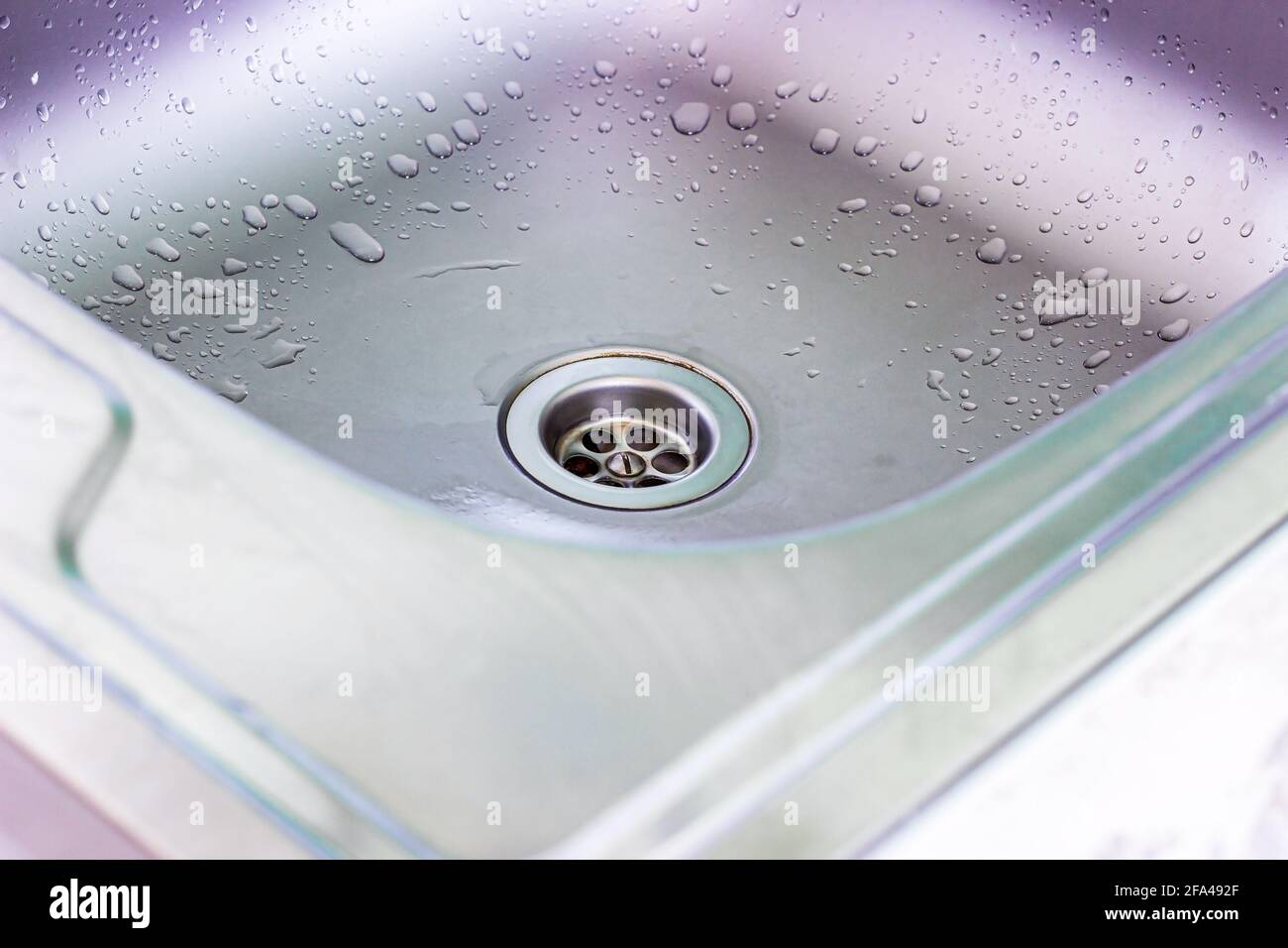 Metal empty sink in the kitchen. Housework, washing dishes, household ...