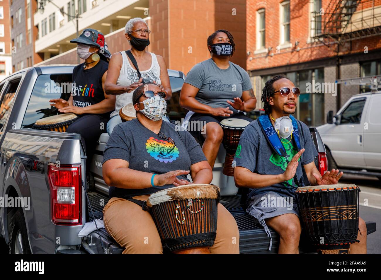A group of Black protesters drum in back of moving truck bed Stock ...