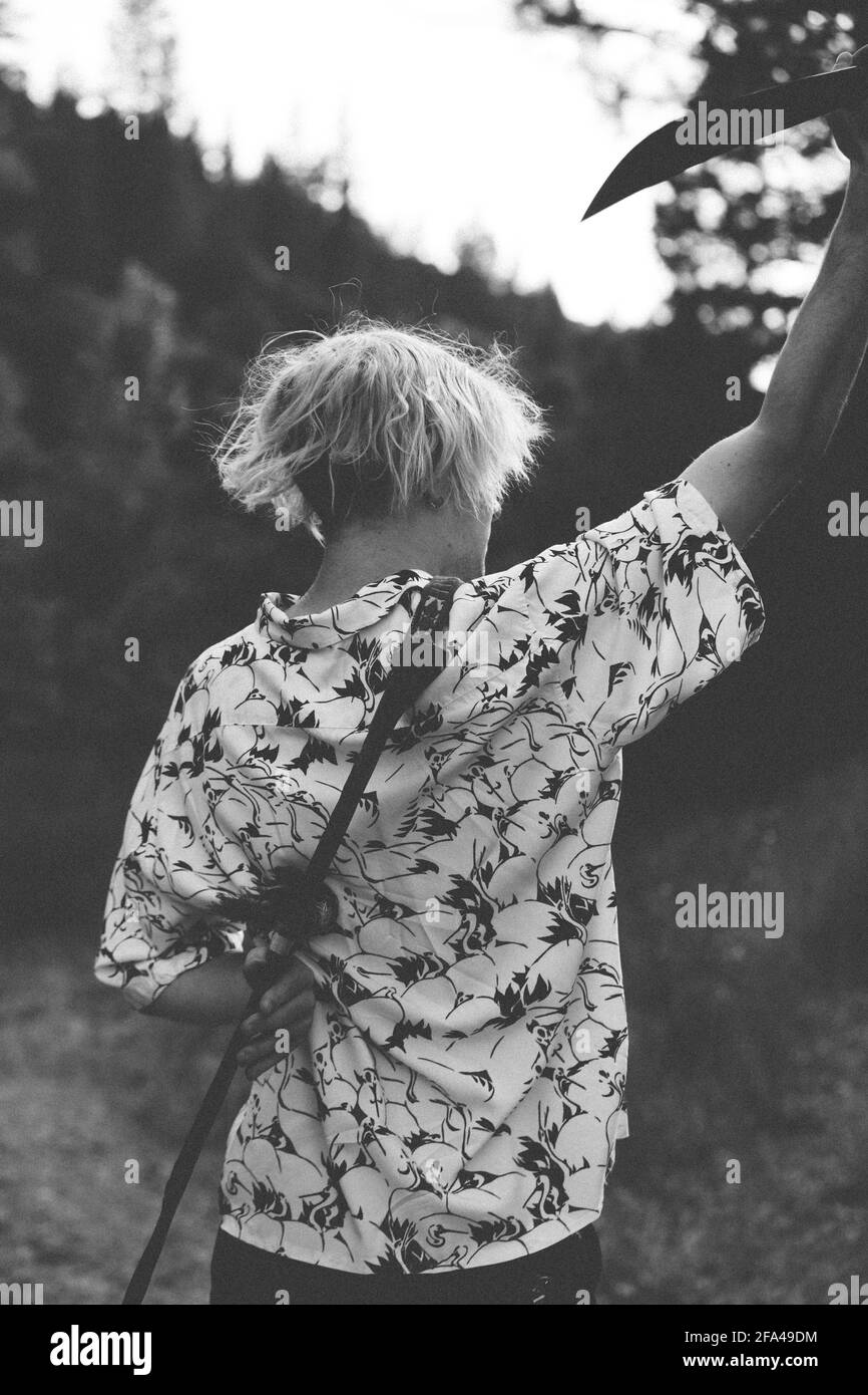Teen Boy Pulls Machete from a Holster on his Back Stock Photo - Alamy