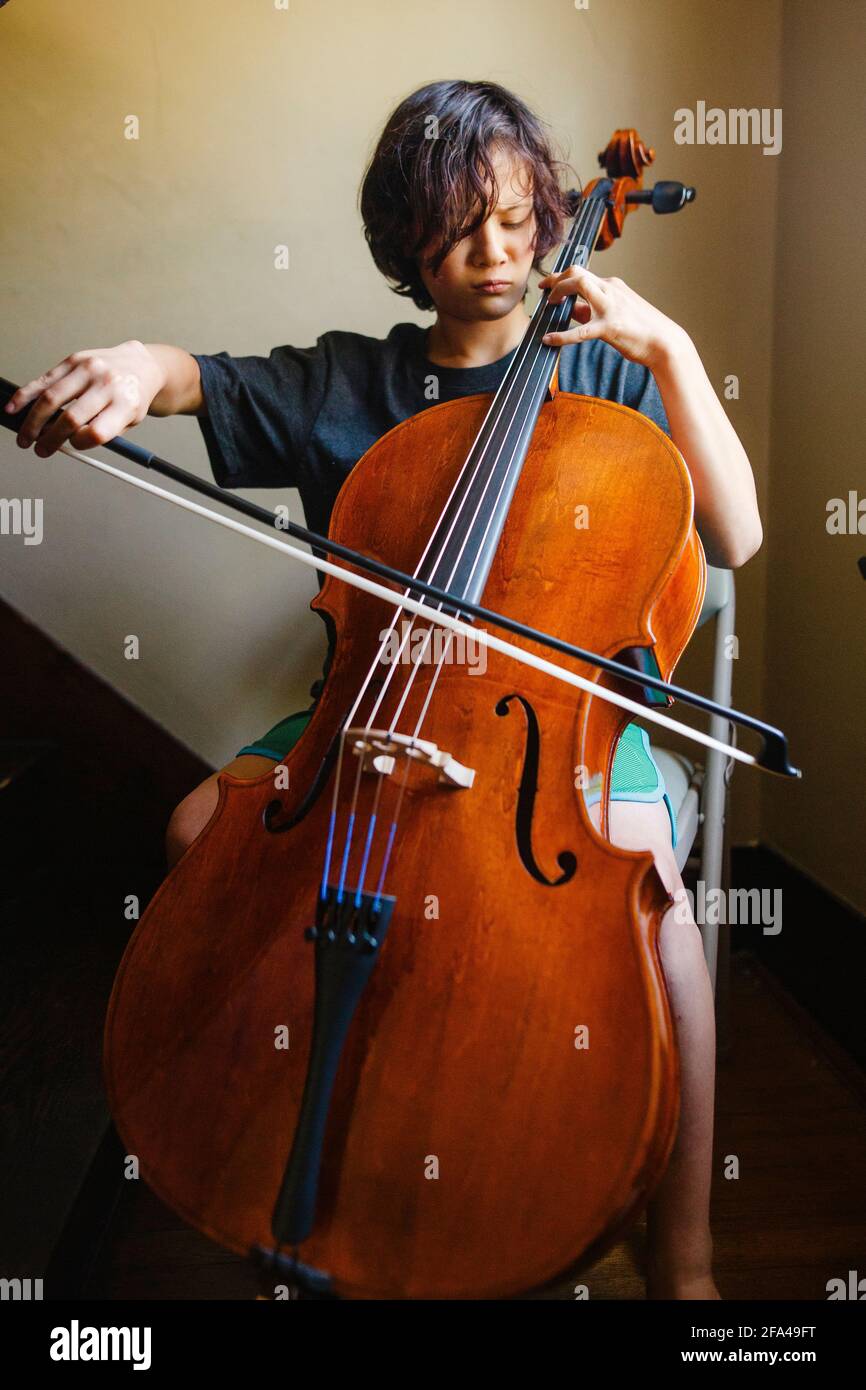 Boy playing cello hi-res stock photography and images - Alamy