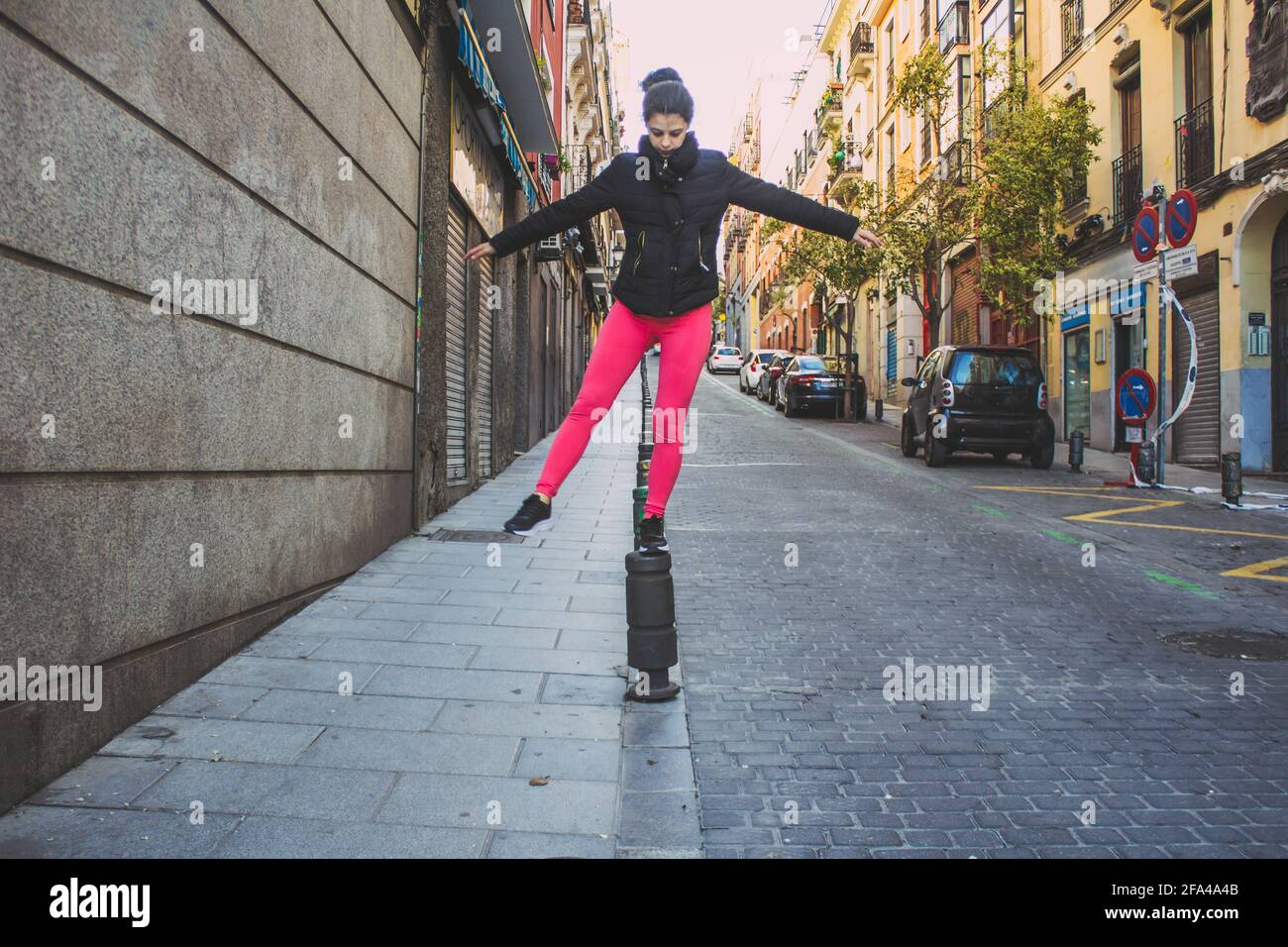 woman balancing on a stick in the street Stock Photo - Alamy