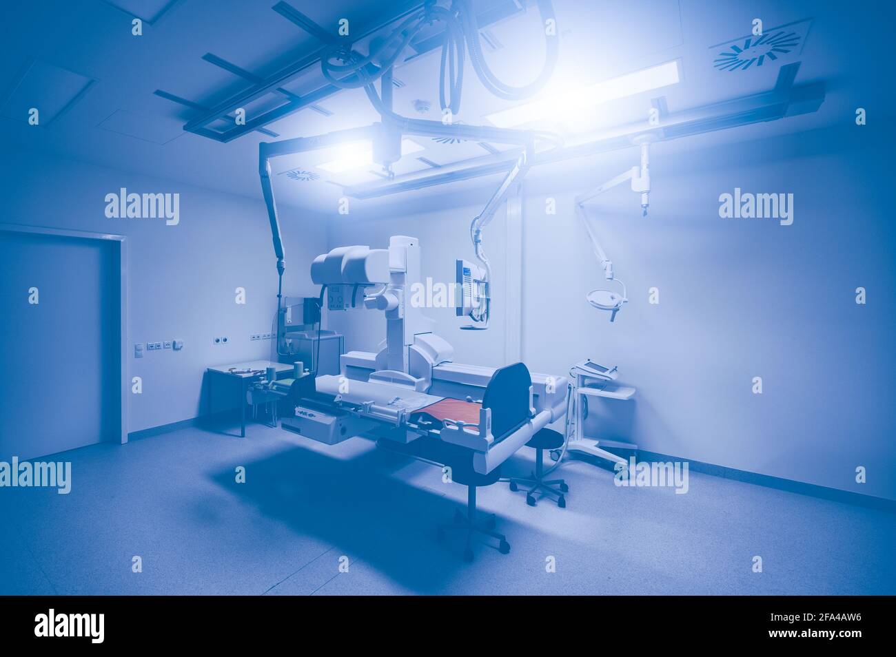X-ray machine in a hospital room with a blue effect Stock Photo - Alamy