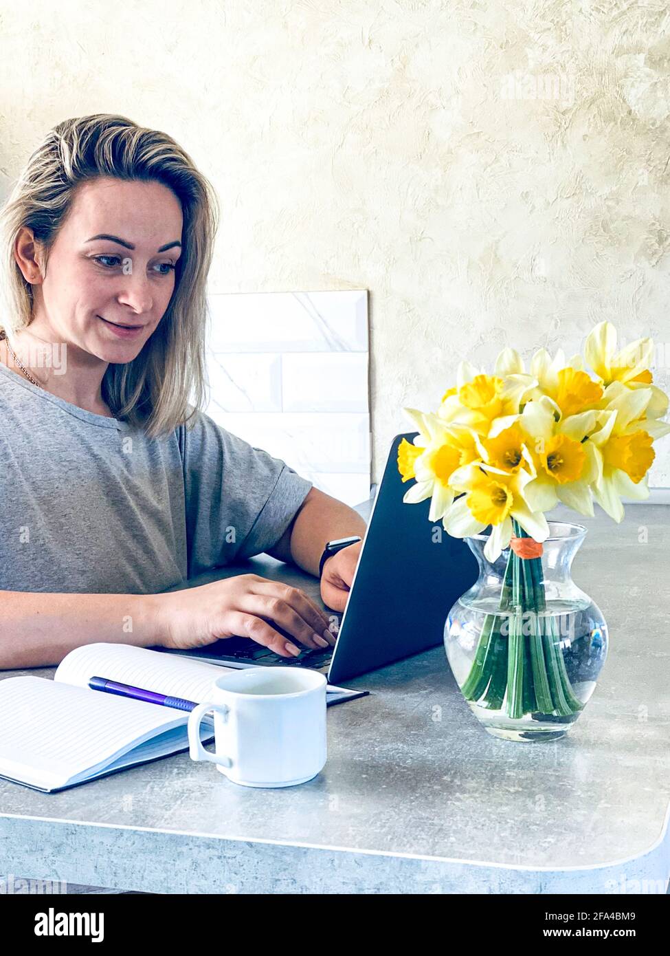 the woman is working at the computer and smiling Stock Photo - Alamy