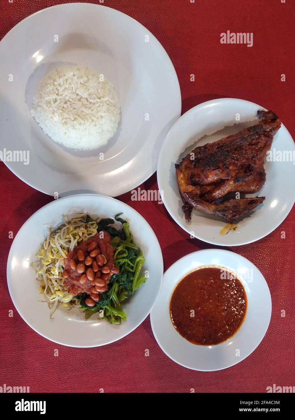 Top view appetizing food assortment on plates on a red tablecloth Stock ...
