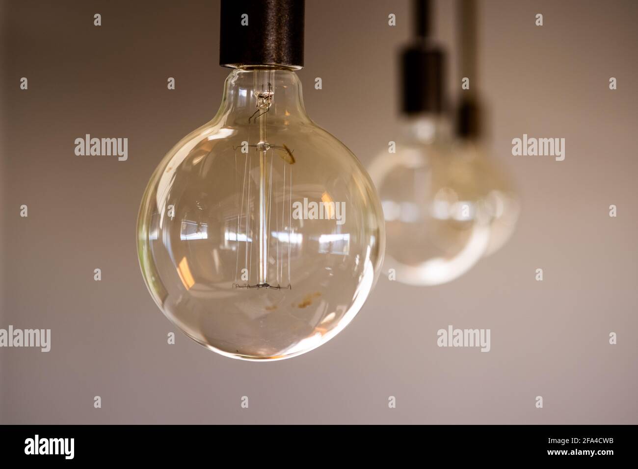 Light bulb hanging from ceiling hi-res stock photography and images - Alamy