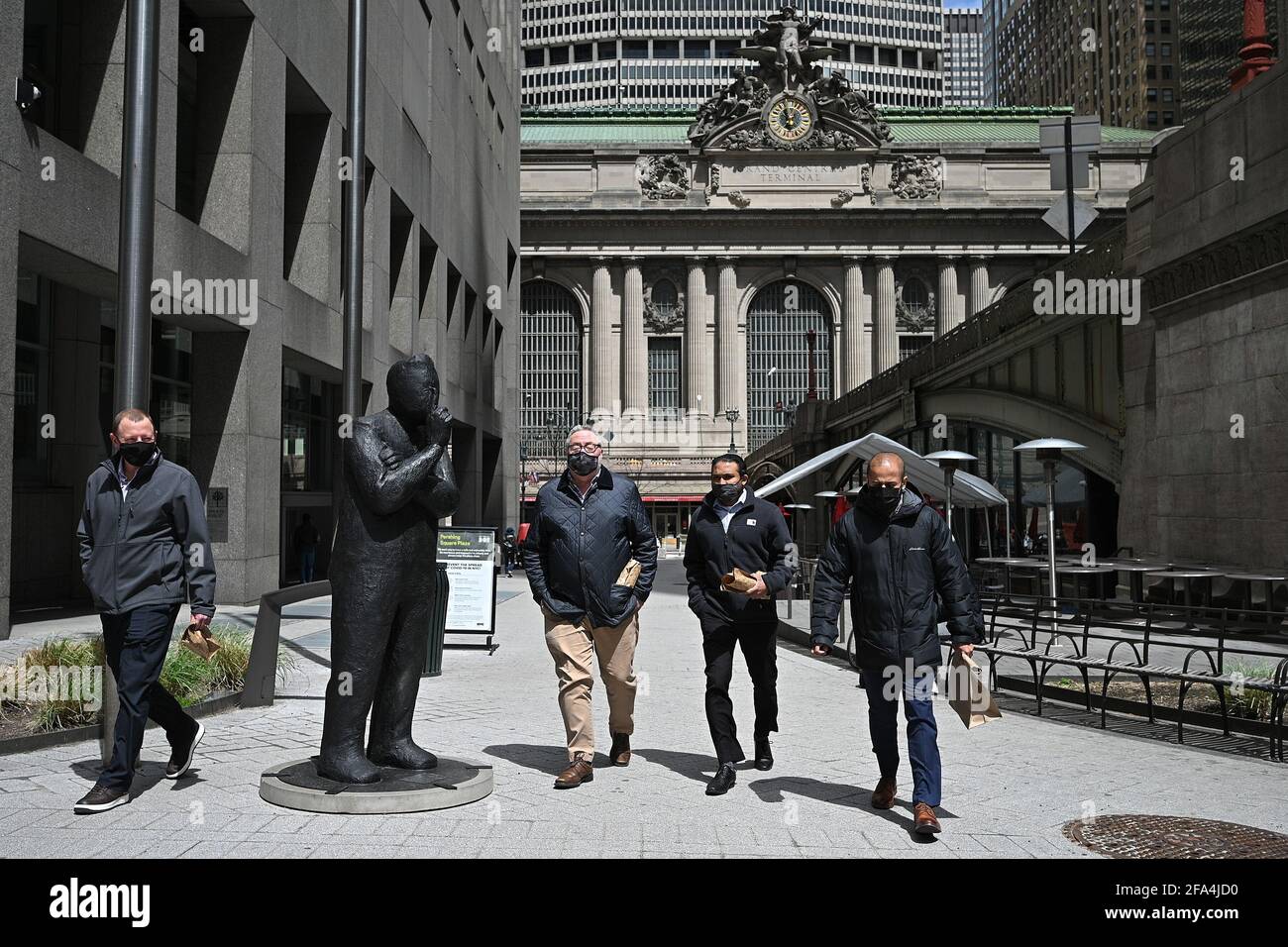 New York, USA. 22nd Apr, 2021. Three men walk in unison past “Listen ...