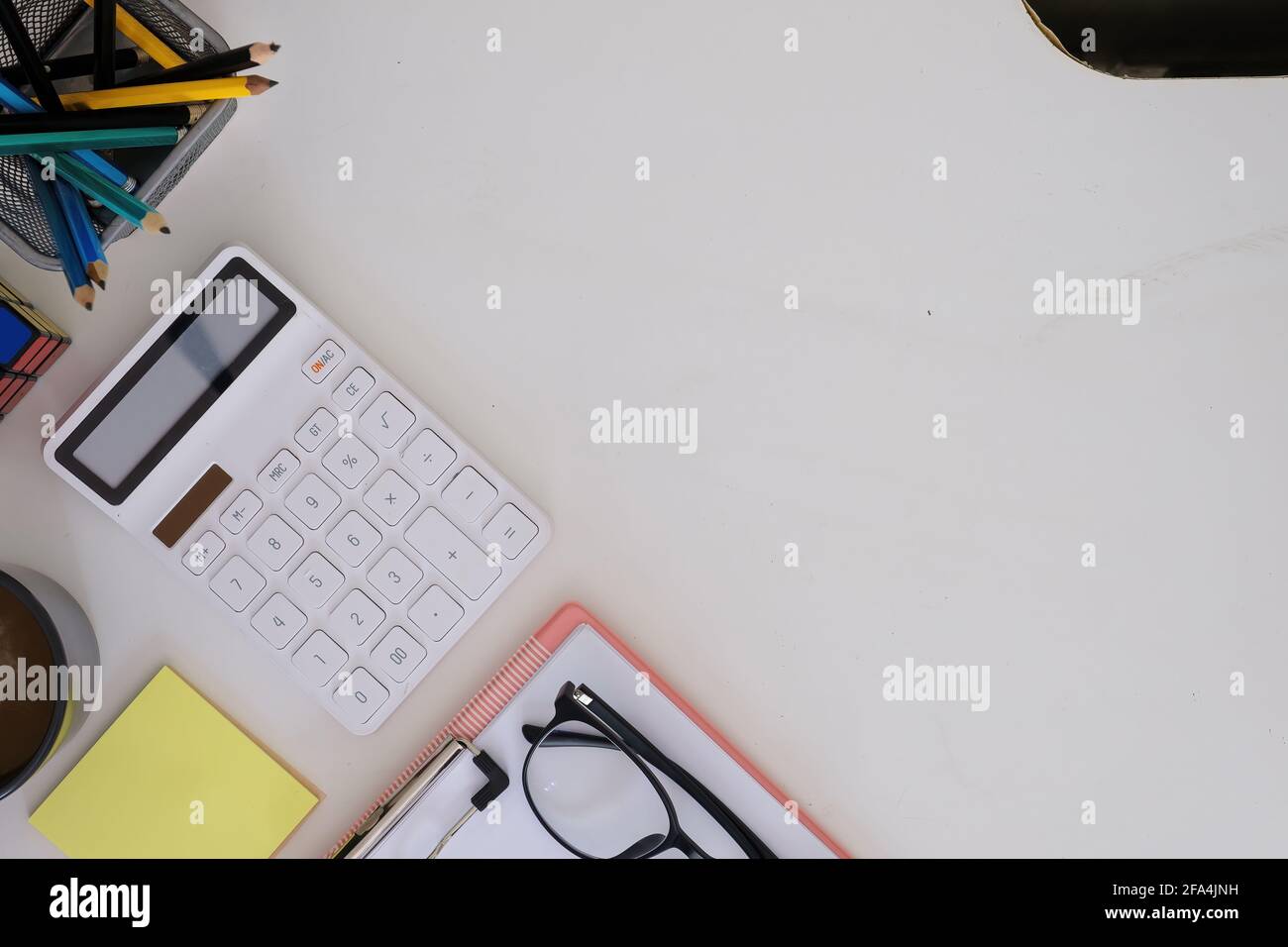Modern white wooden desk table calculator and business tools office ...