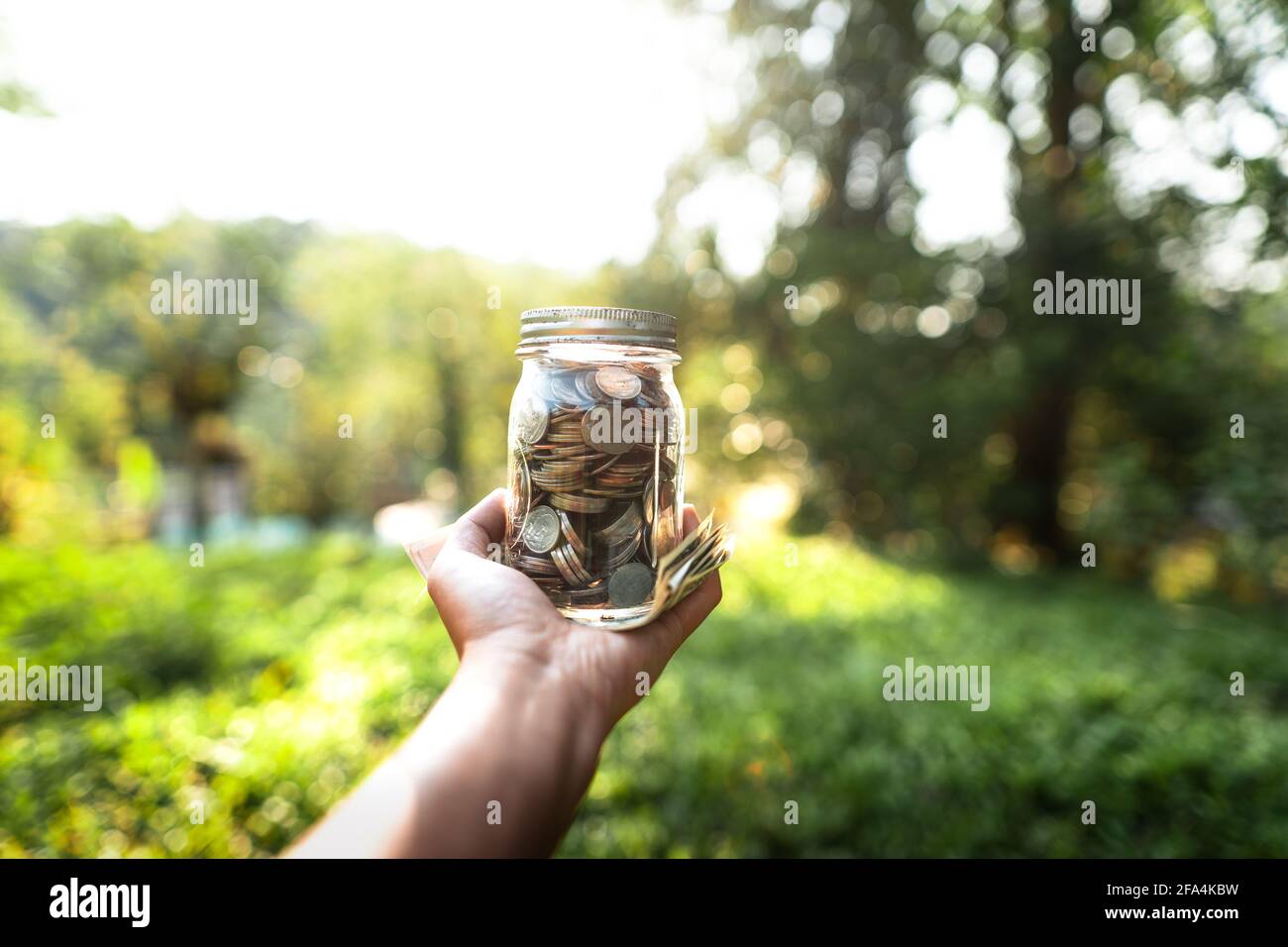 Money in hand save money Stock Photo - Alamy