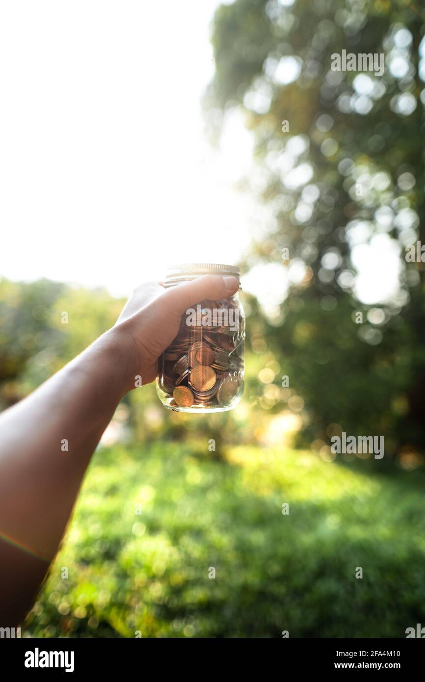 Money in hand save money Stock Photo - Alamy