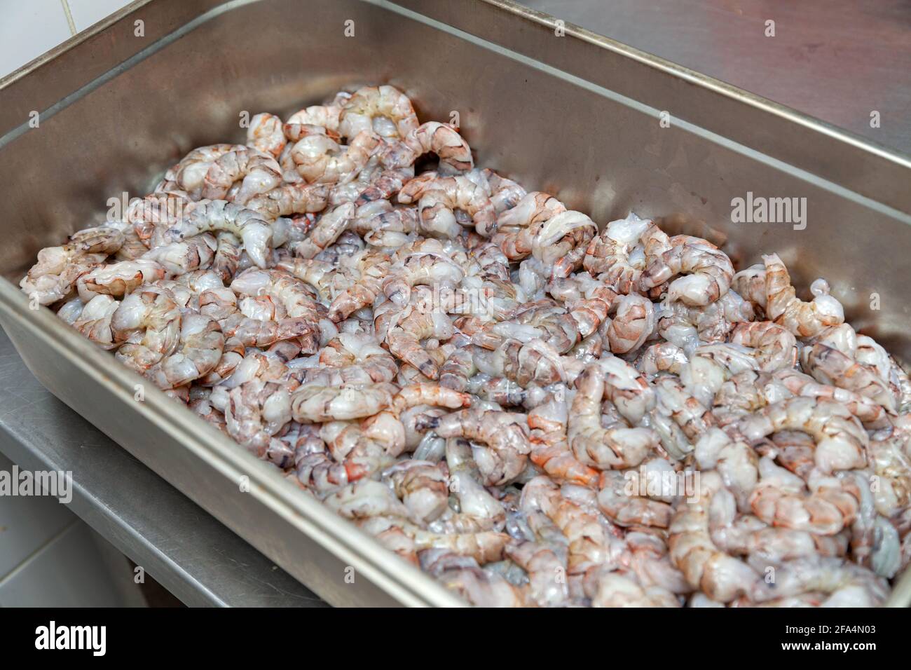 Many peeled raw headless large shrimps without shell Stock Photo - Alamy