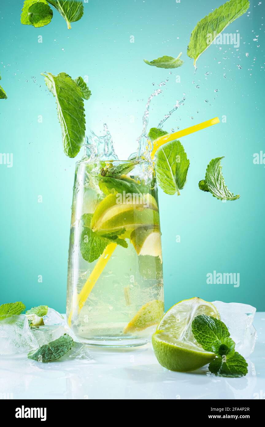 Mojito with mint and ice. Flying spray and mint. A vivid photograph of ...