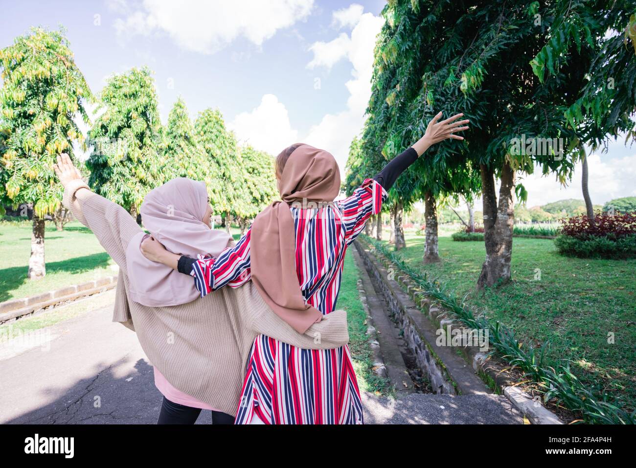 Two friends muslim enjoying the summer sun Stock Photo - Alamy