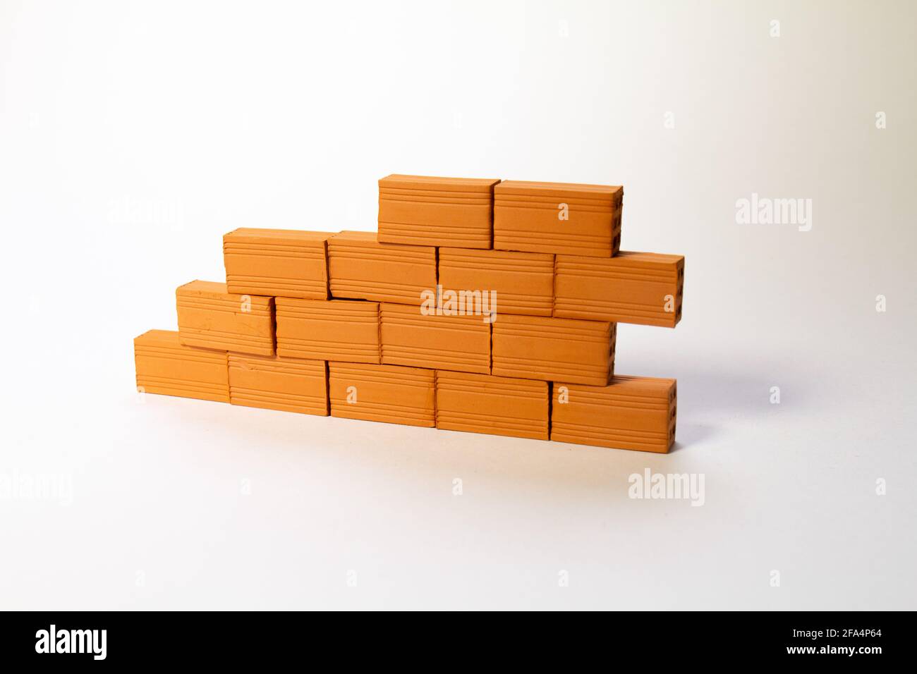 A wall of toy bricks on a white background Stock Photo - Alamy