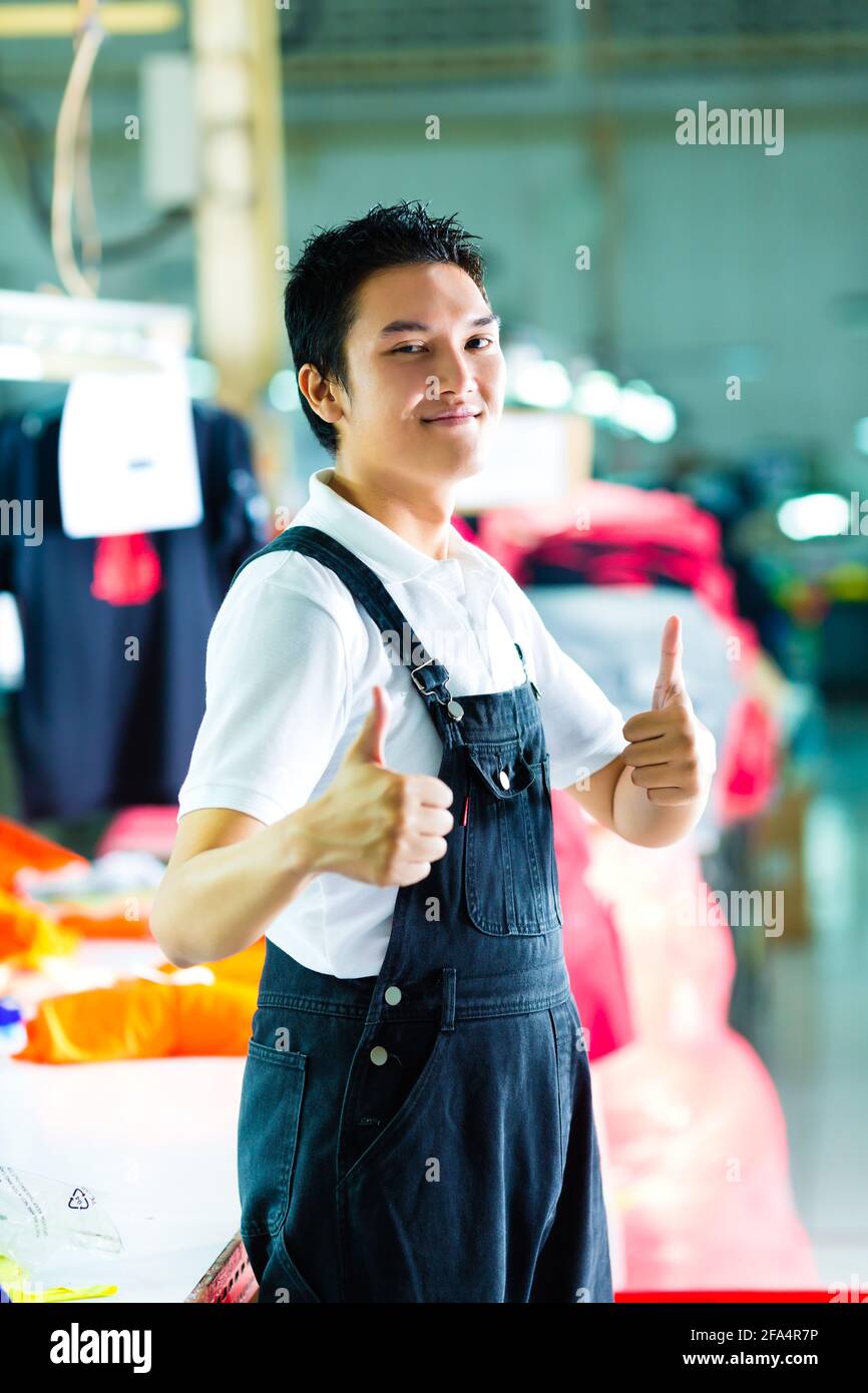 Worker or production manager standing proudly in a Chinese textile ...