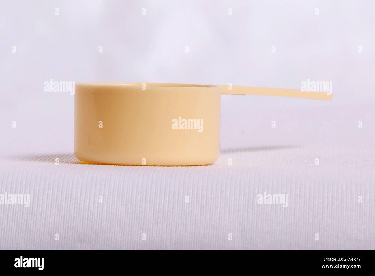 A plastic spoon which is used for milk powder mixture Stock Photo - Alamy