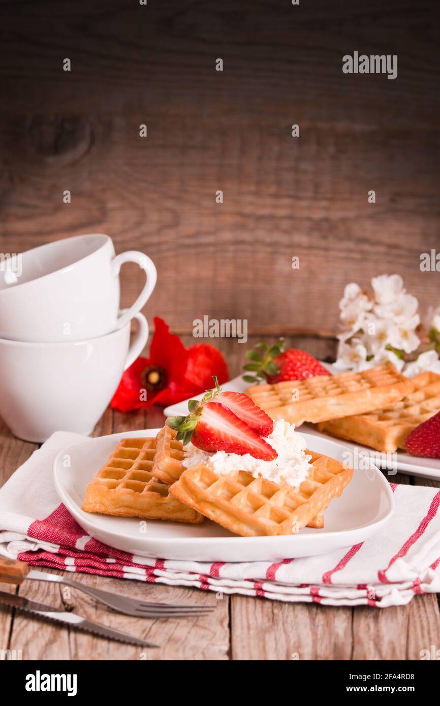 Waffles with strawberries and whipped cream Stock Photo - Alamy
