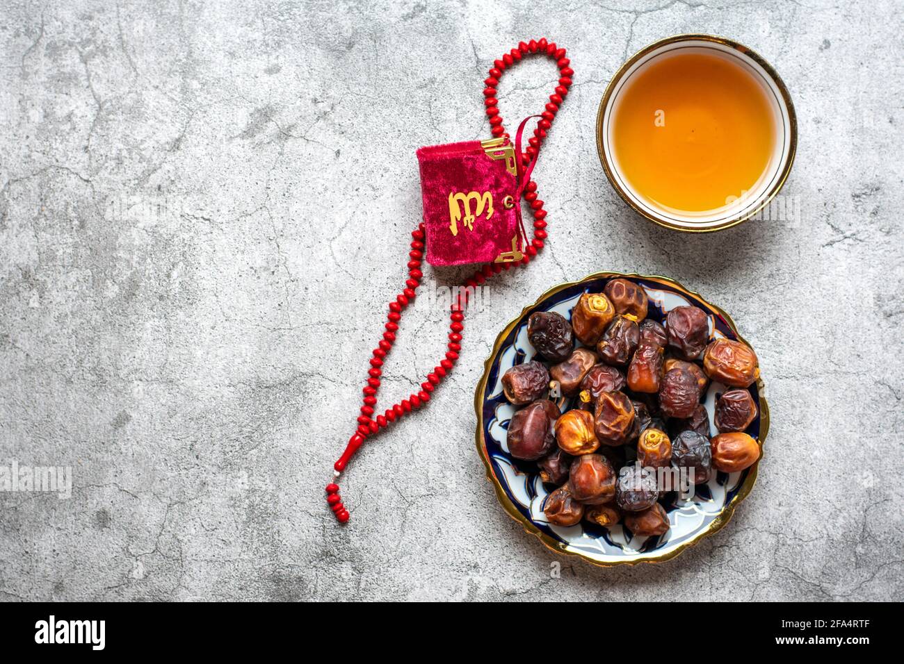 Popular food during Iftar - dry dates. Karan, rosary on concrete ...