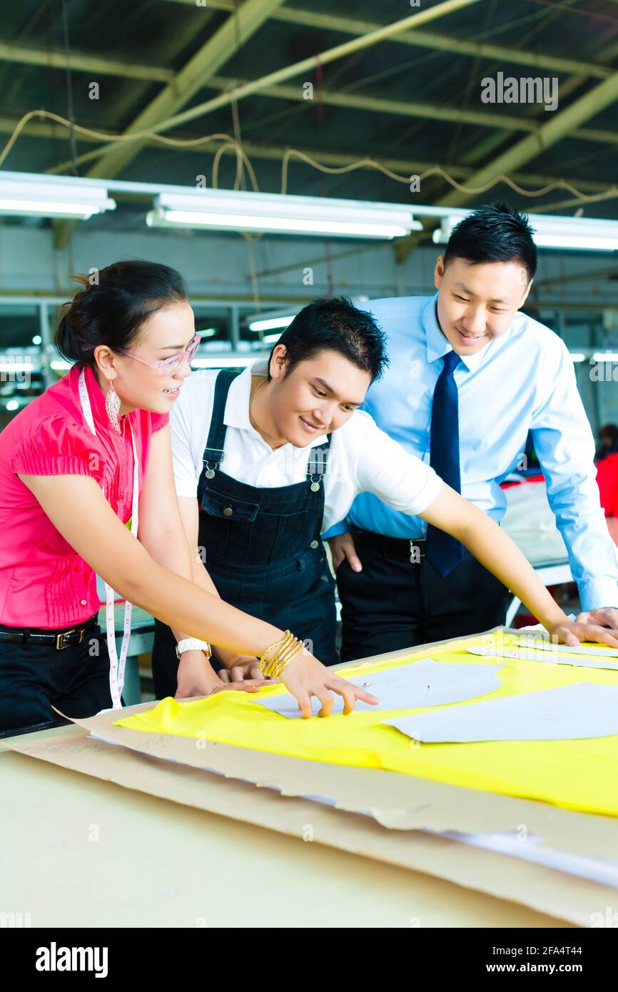 Female Designer or a seamstress, sewer, worker or production manager ...