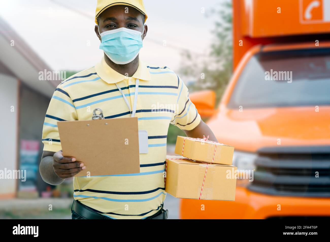 African american delivery man carrying hi-res stock photography and ...