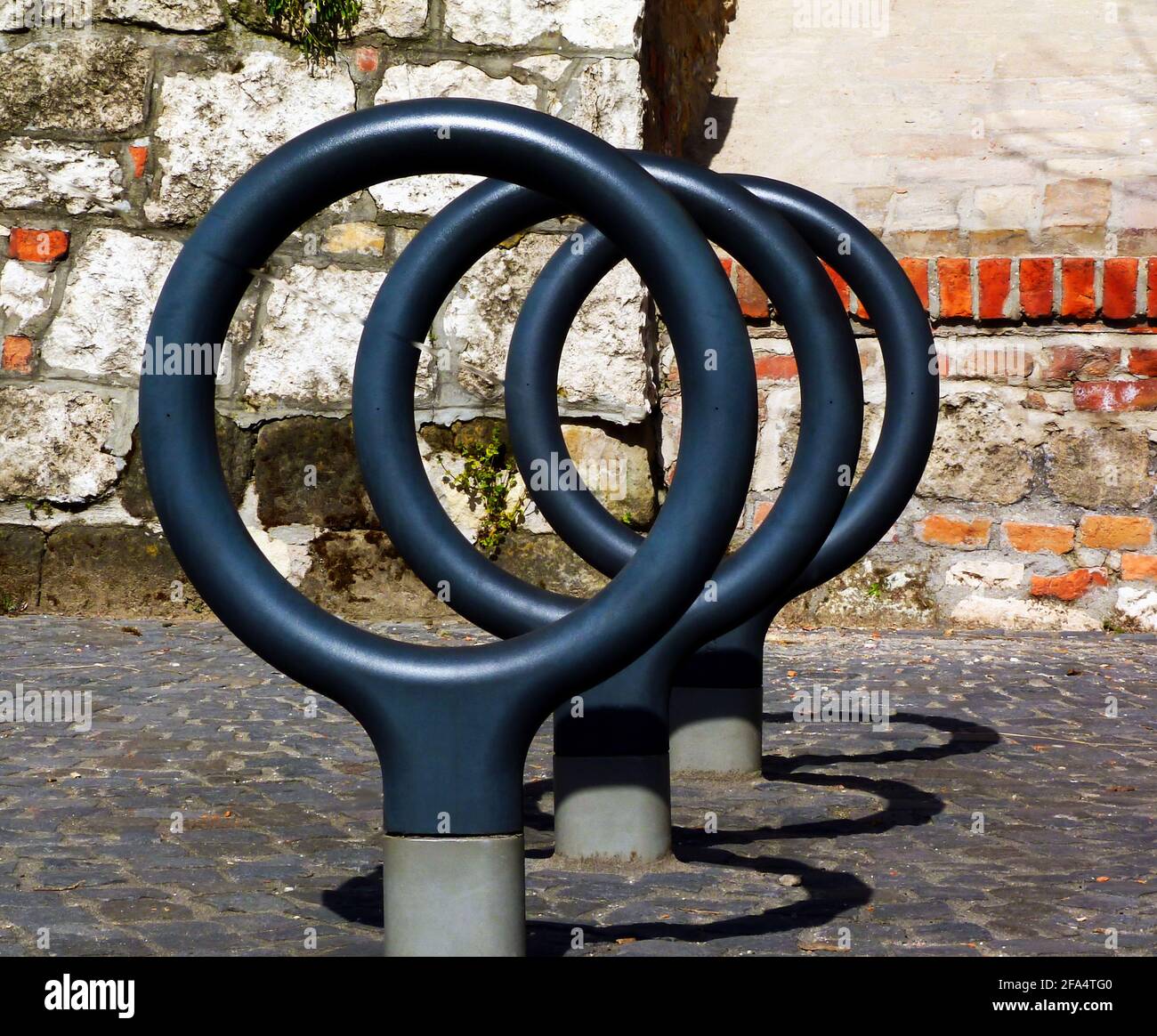 O ring shaped heavy steel bicycle racks cast in cobblestone paving. old ...