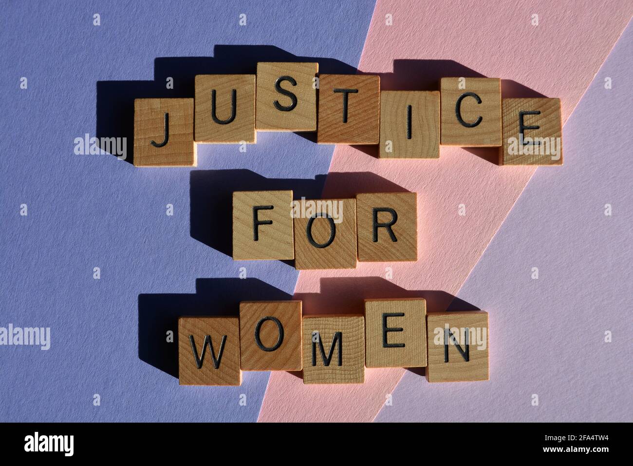 Justice For Women, words in wooden alphabet letters isolated on pastel ...