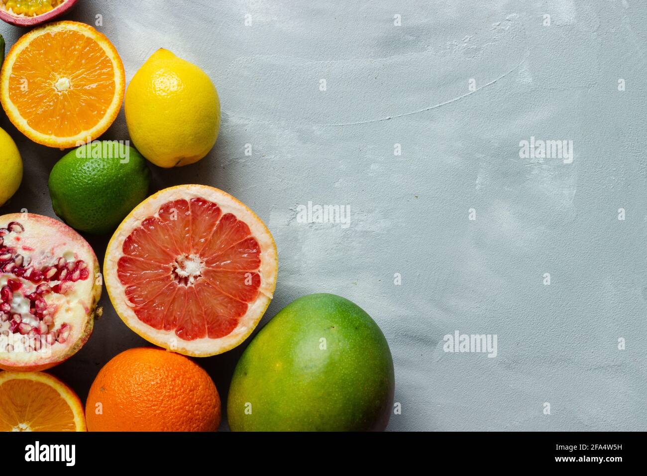 Colorful tropical fruits on gray background Stock Photo - Alamy