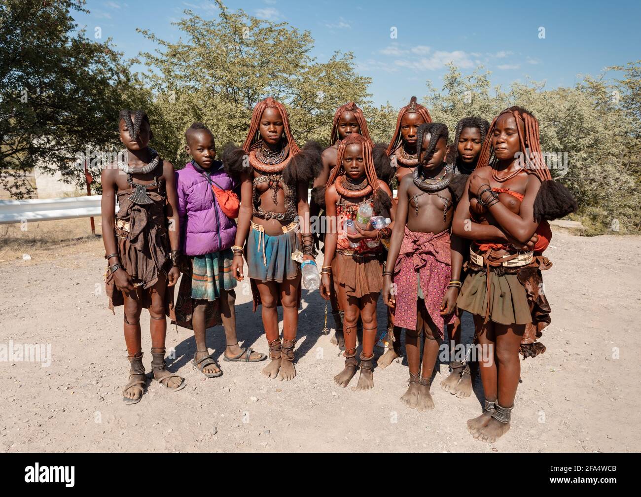 NAMIBIA, OMUSATI REGION, MAY 7: Group of young Himba woman with traditional hairstyle and red ...