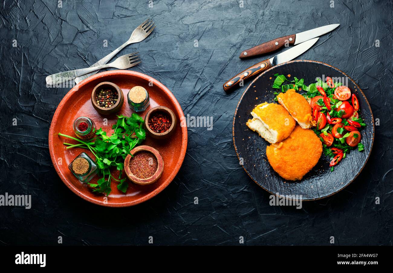 Homemade Kiev cutlet with spring vegetable salad Stock Photo - Alamy