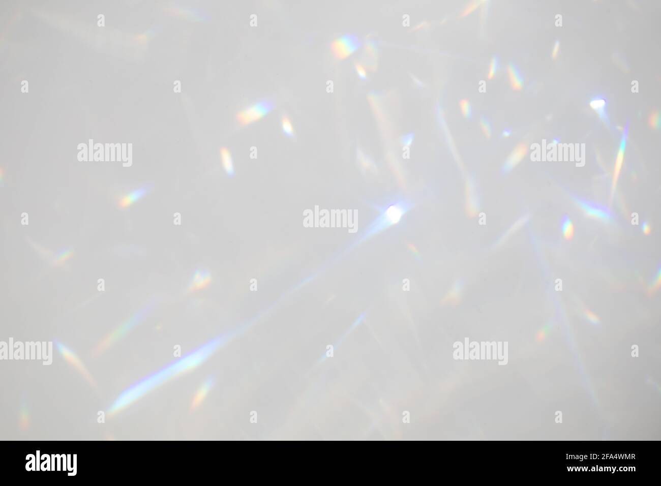Blurred rainbow light refraction texture on white wall Stock Photo - Alamy
