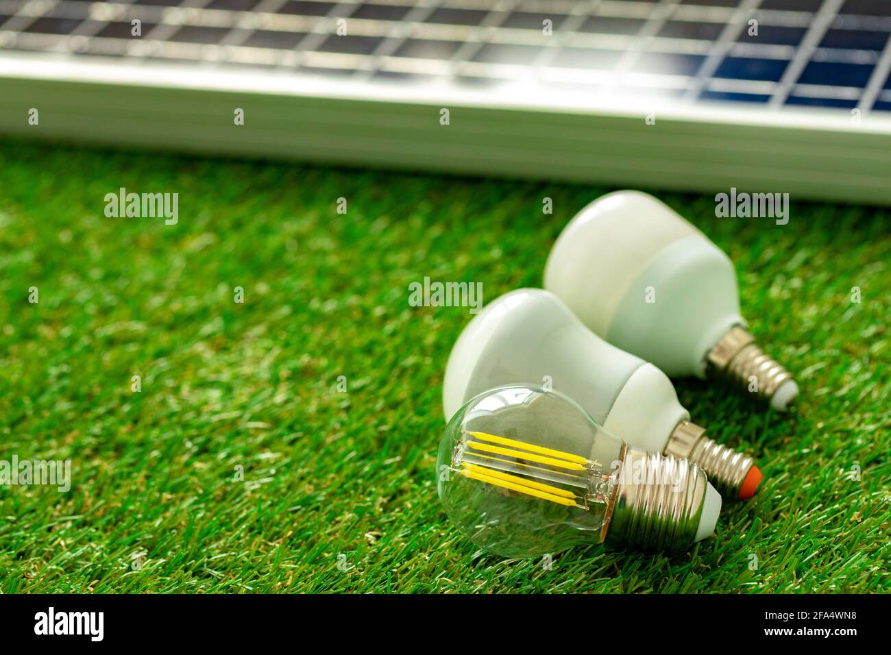 Solar energy panel and light bulb, green energy Stock Photo - Alamy